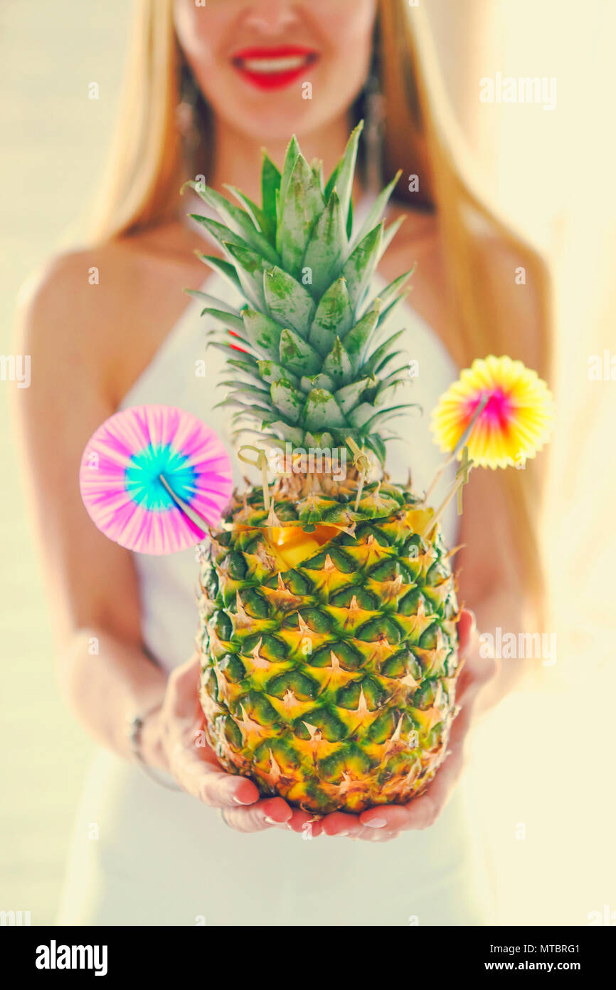 Pina colada in pineapple in woman hands Stock Photo - Alamy