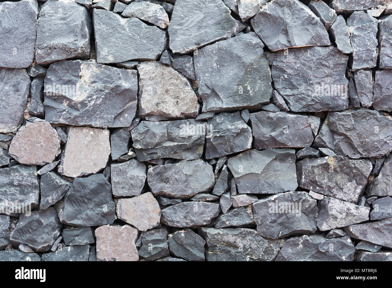 Stones of different shapes and sizes are built into the wall Stock ...