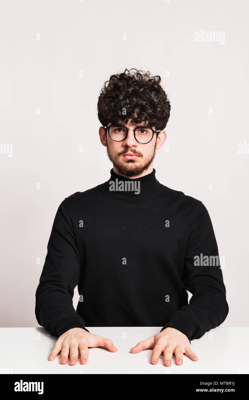 Young man sitting one hand hi-res stock photography and images - Alamy