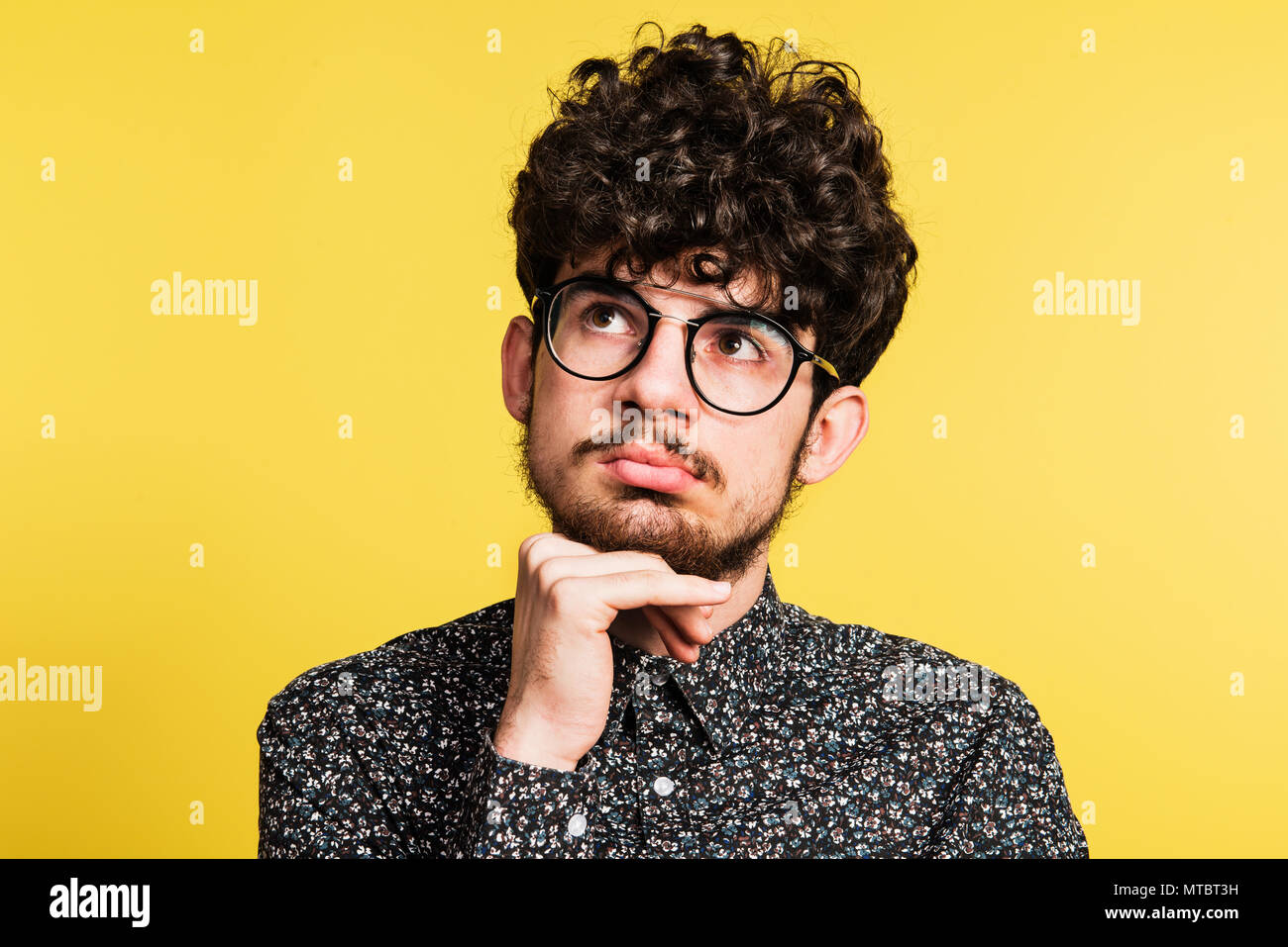 Studio portrait of a young man on a yellow background Stock Photo - Alamy