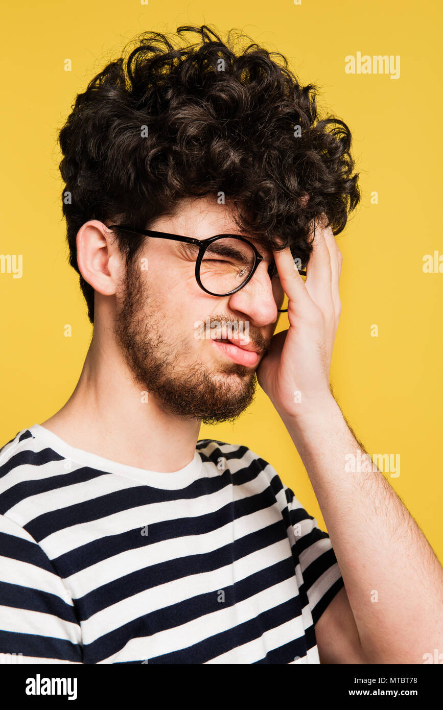 Studio portrait of a young man on a yellow background Stock Photo - Alamy