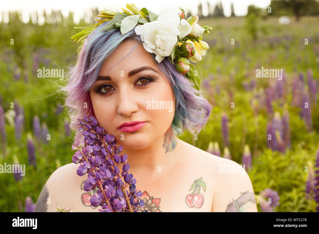 portrait of sensual attractive tattoo bride in lupines field Stock ...