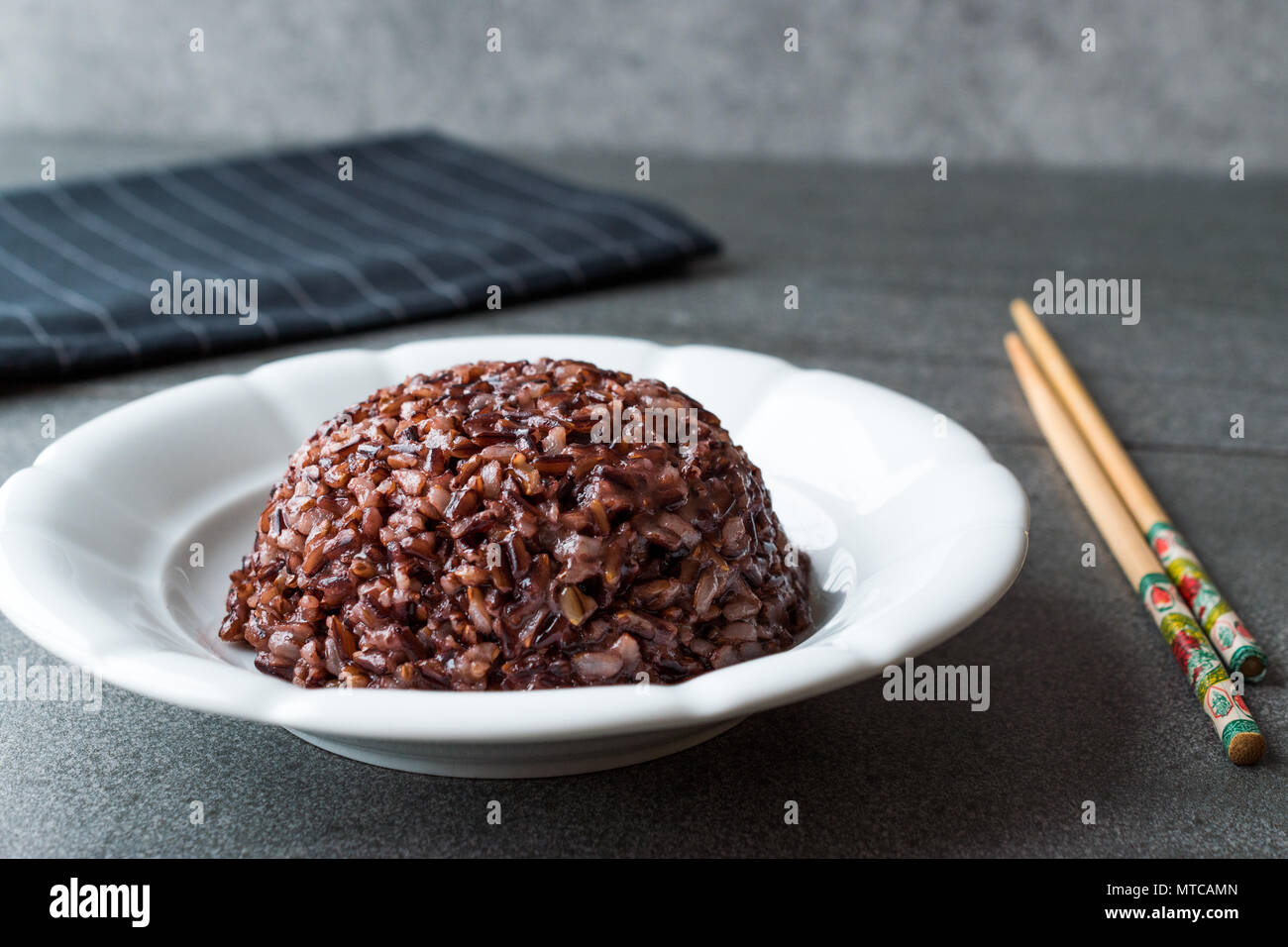 Cooked Black Rice in white Plate with Chopsticks. Traditional Organic ...