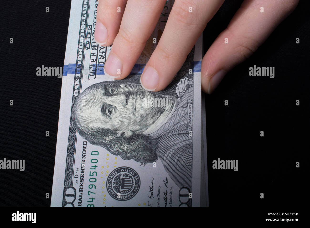 Hand holding American dollar banknotes isolated on white background ...