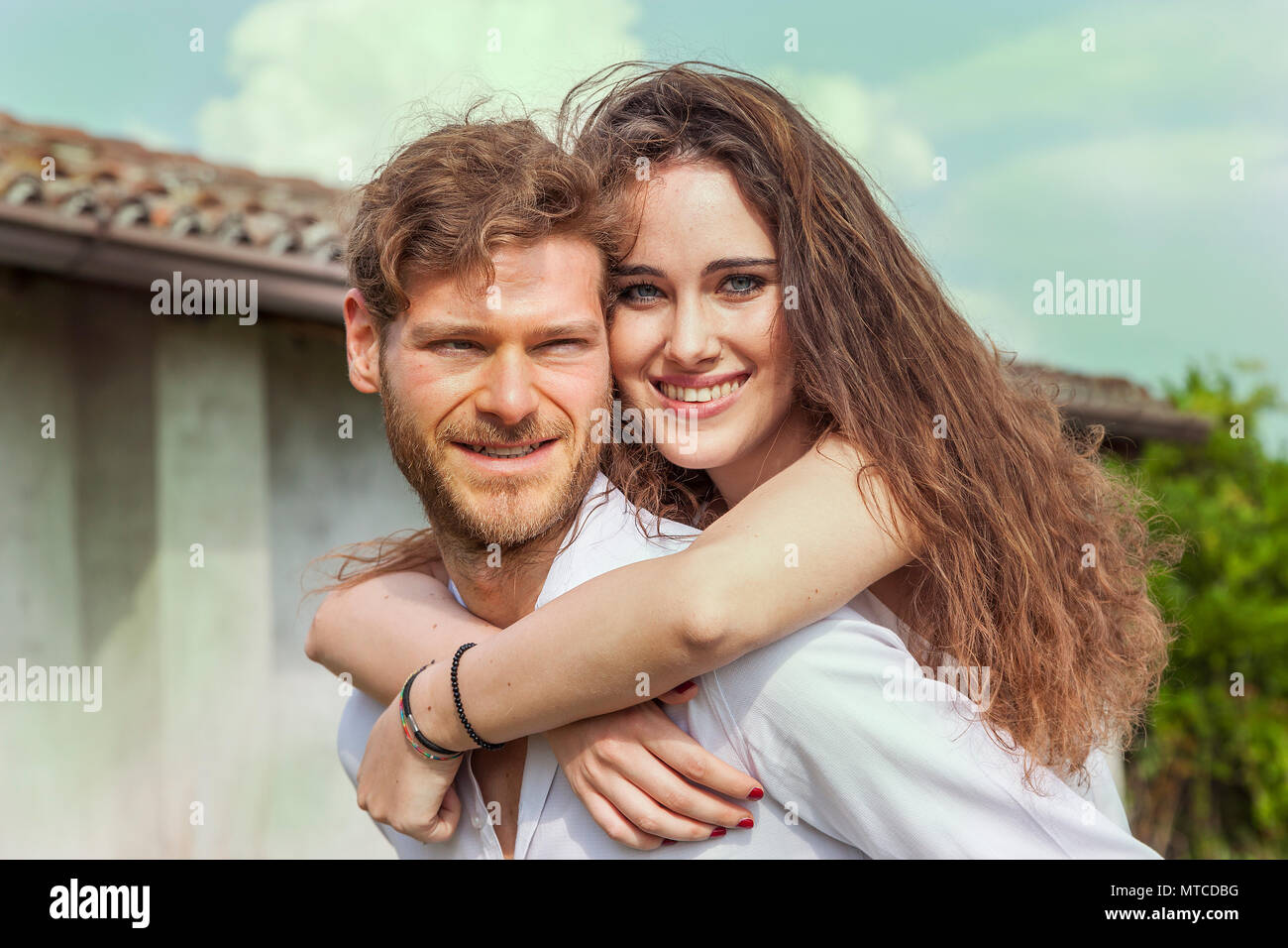 group of young handsome people walk together laughing on a country road ...