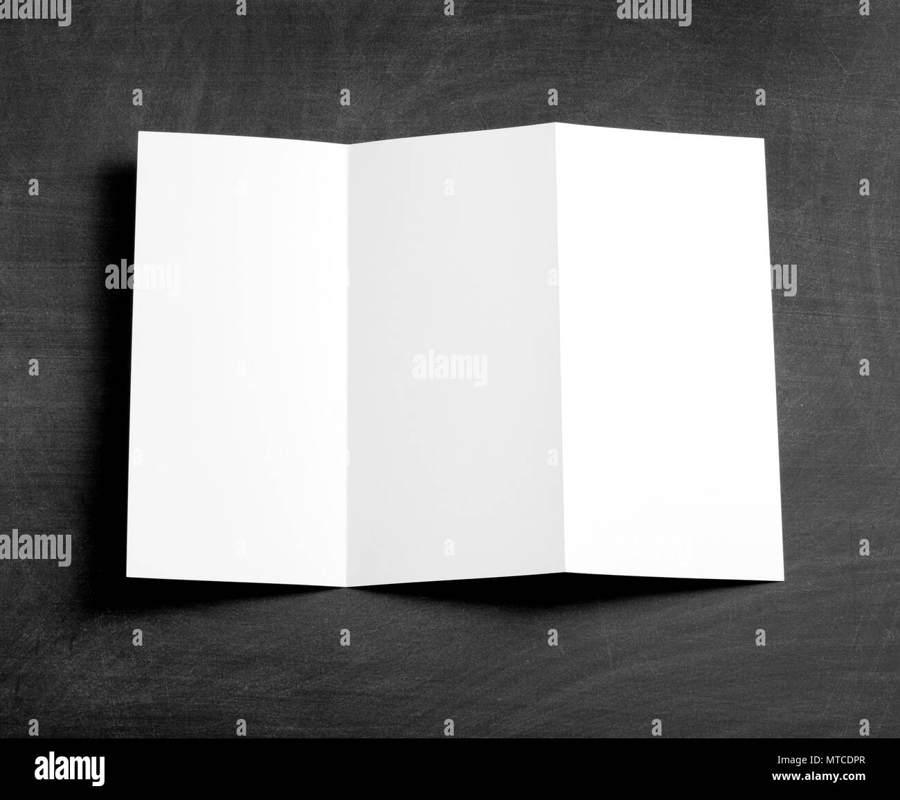 Blank folding page booklet on a black chalkboard Stock Photo - Alamy