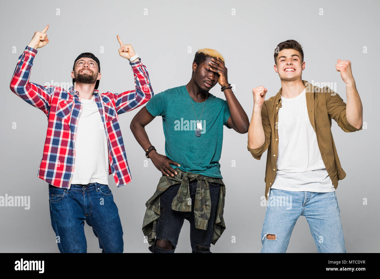 Three young men fans suporters with different emotions isolated on ...