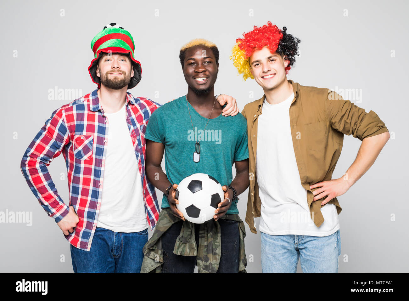 Three fans of sport teams celebrate victory and support their teams ...