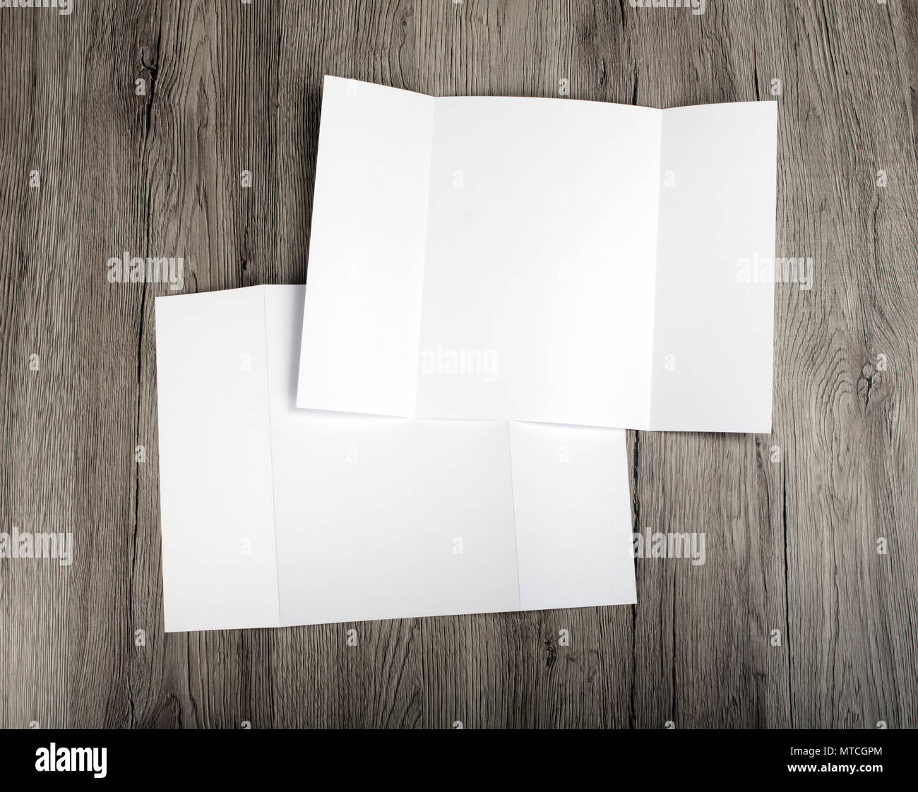 Blank gate fold brochure on wooden background to replace your design ...