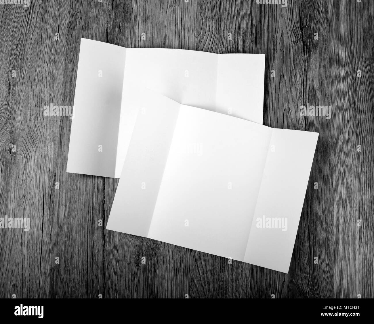 Blank gate fold brochure on wooden background to replace your design ...