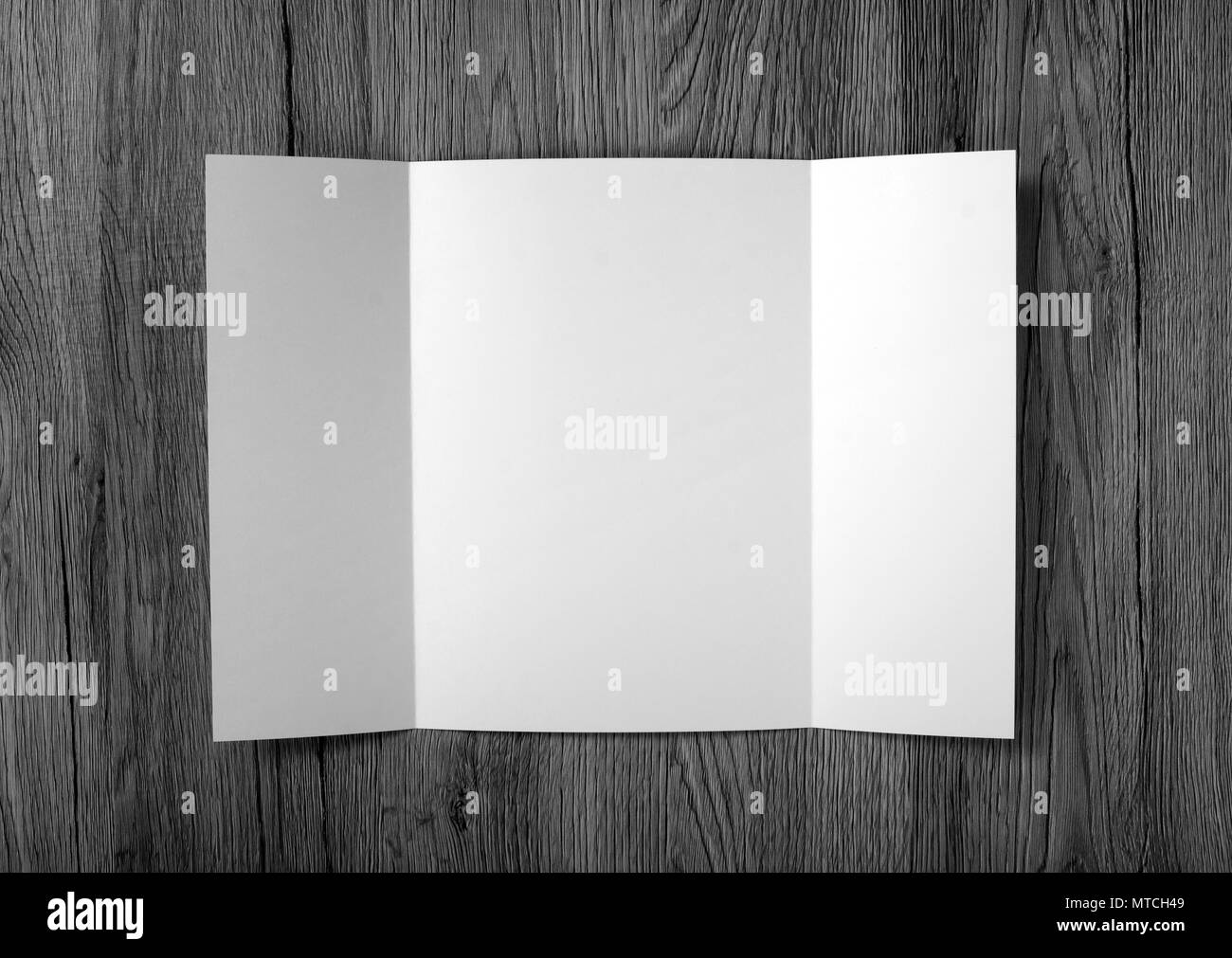 Blank gate fold brochure on wooden background to replace your design ...