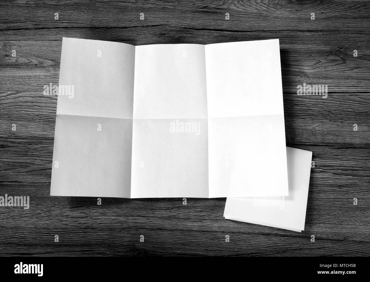 Close up of a crumpled unfolded piece of paper on wooden background ...