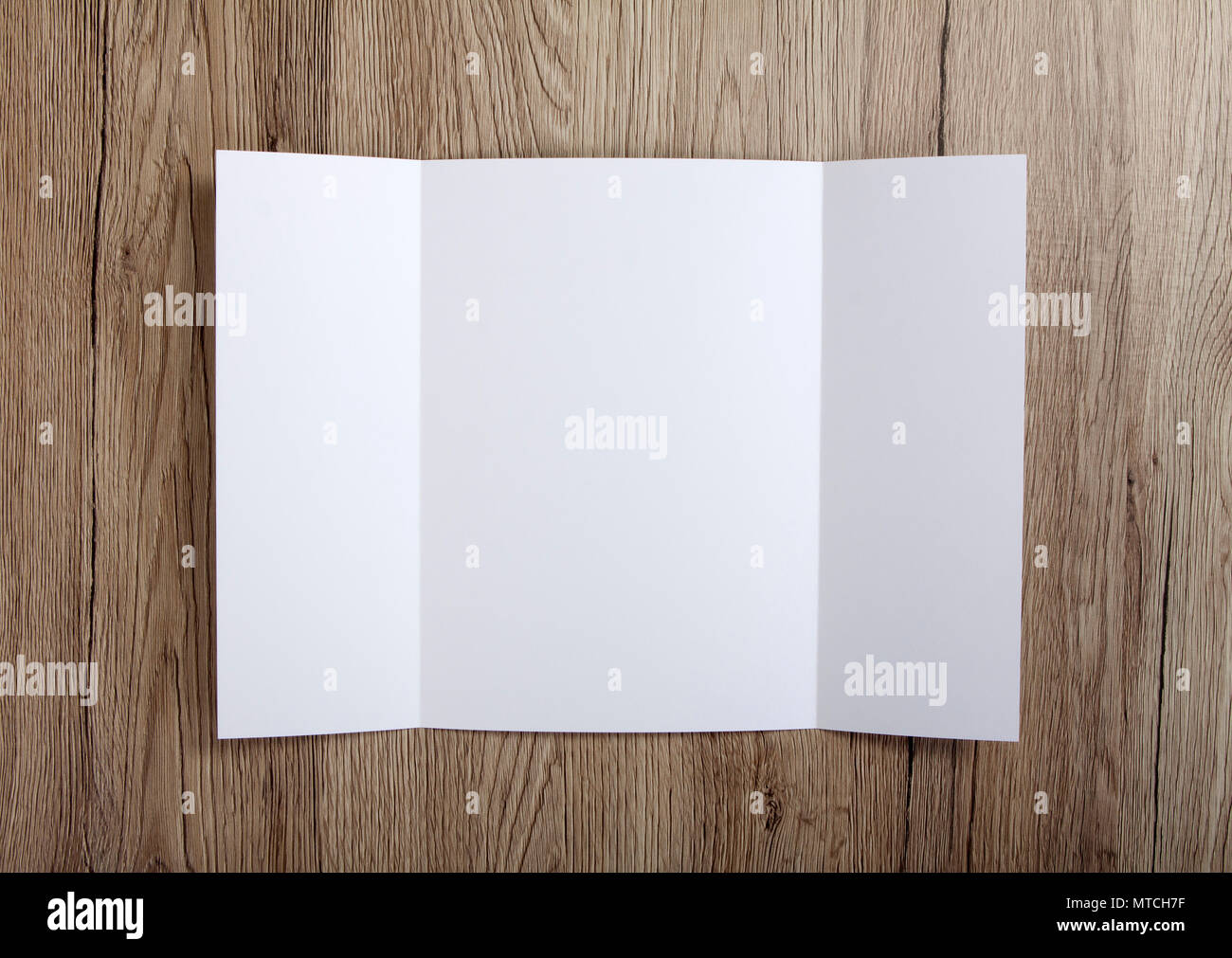 Blank gate fold brochure on wooden background to replace your design ...