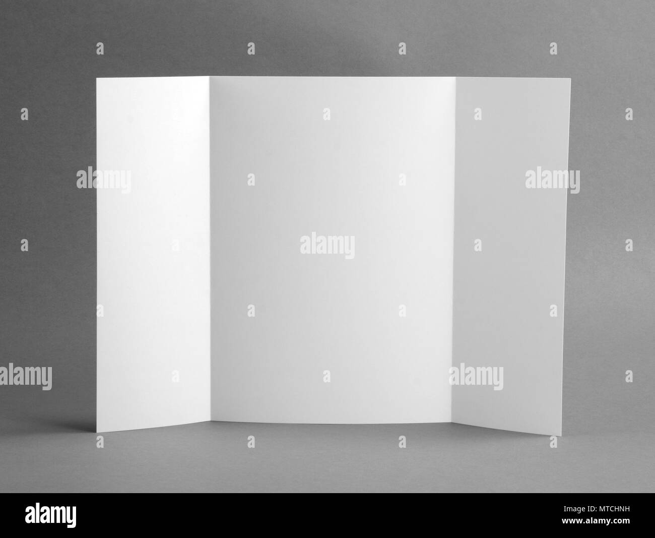 Blank gate fold brochure on grey to replace your design Stock Photo - Alamy