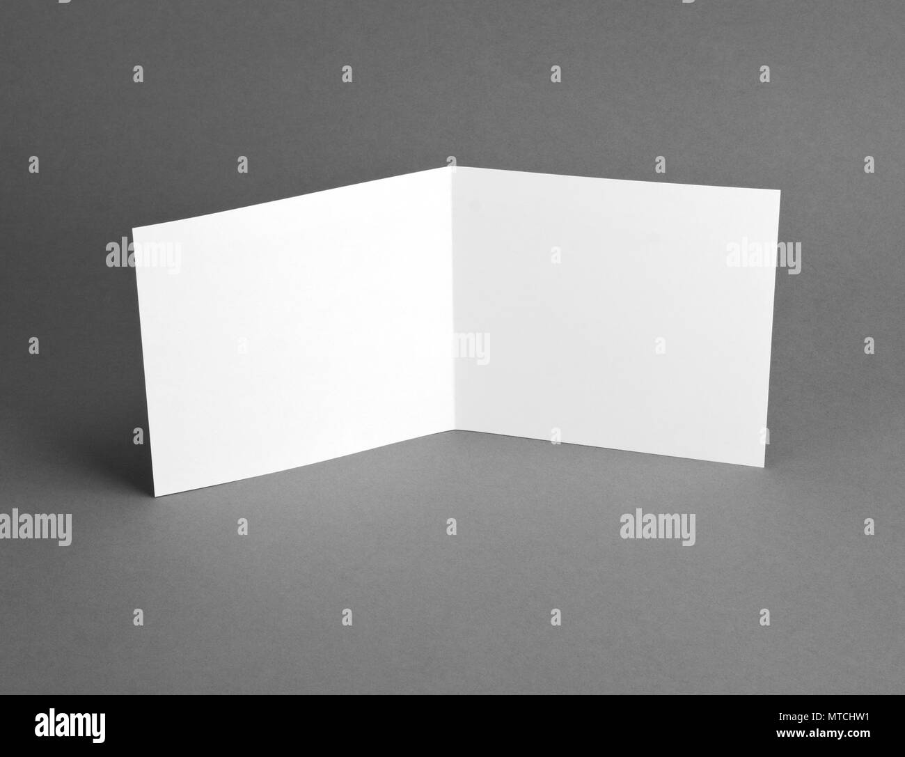White empty open card on grey to replace your design Stock Photo - Alamy