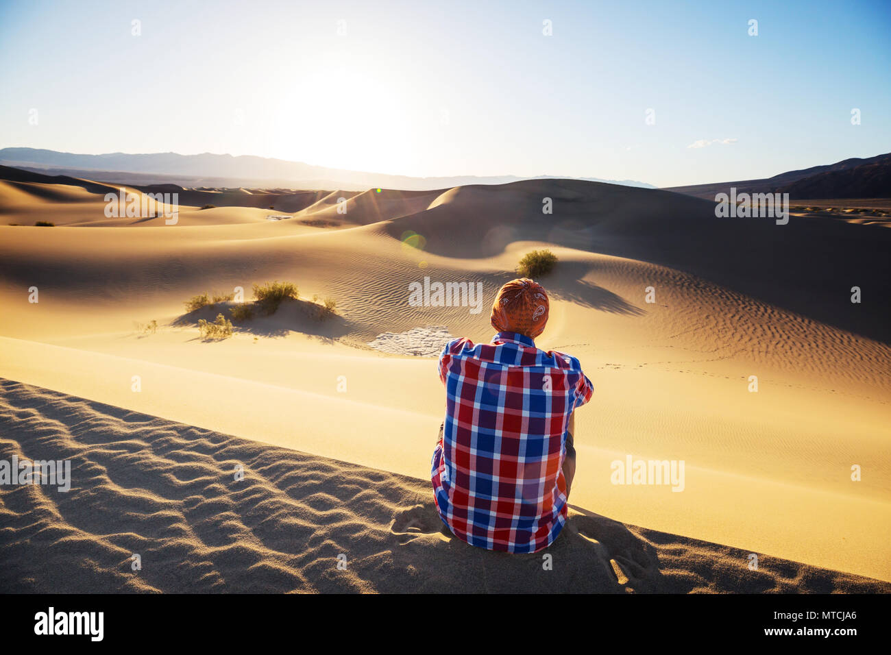 Man in sand desert Stock Photo - Alamy