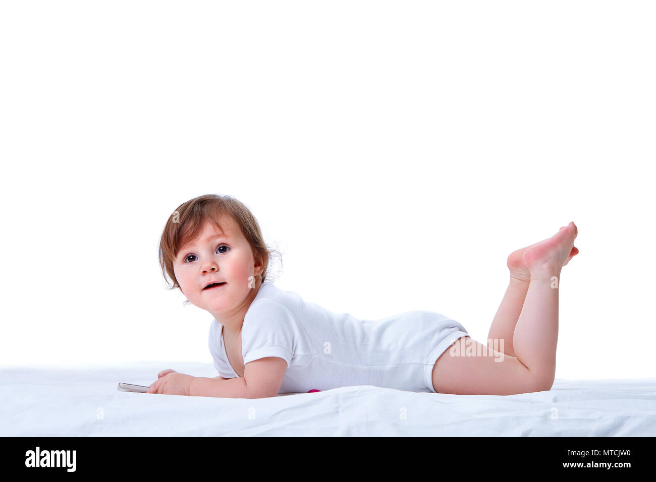 Cute baby girl inwhite body, crawling, laughing and playing at studio ...
