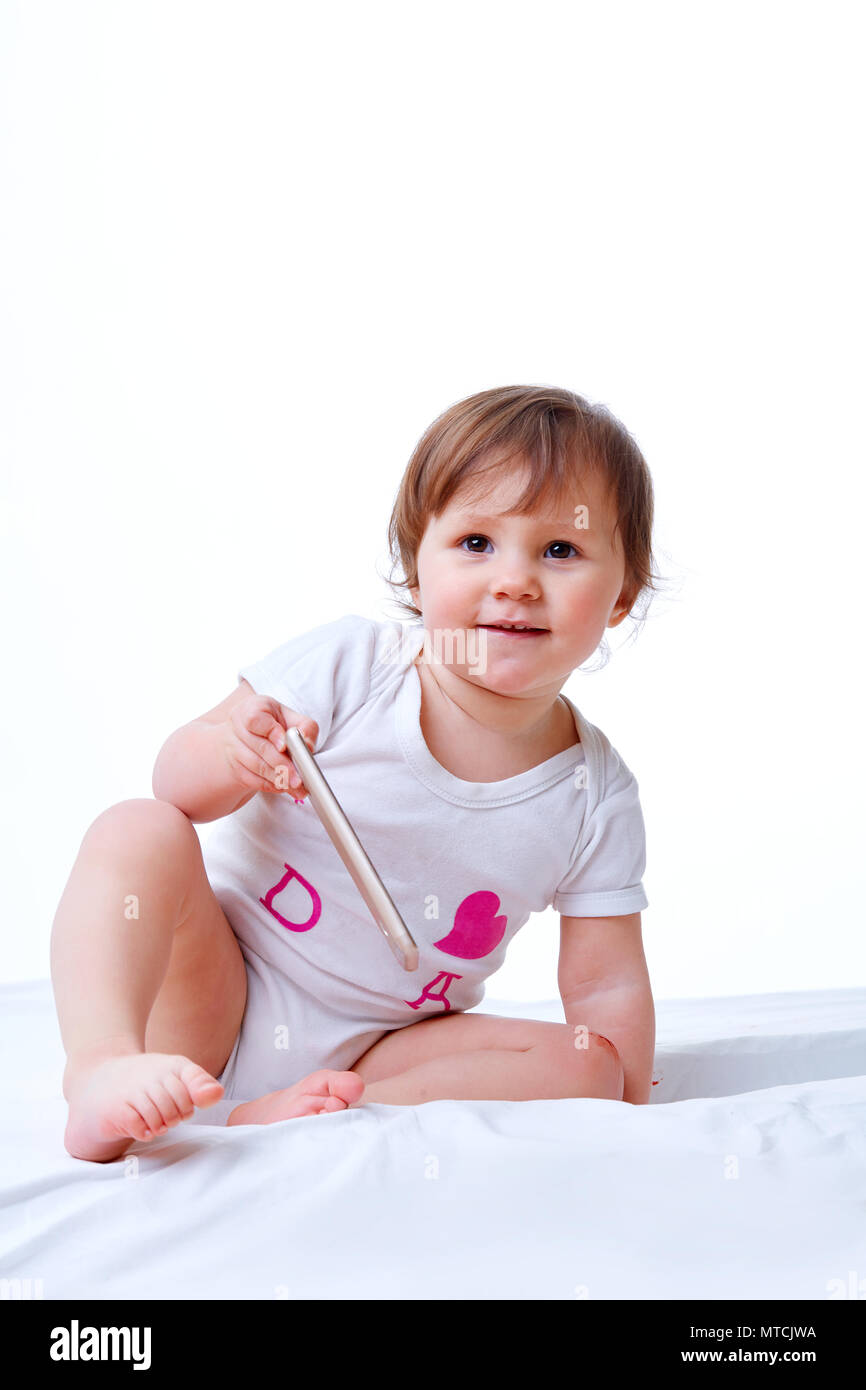 Cute baby girl inwhite body, crawling, laughing and playing at studio ...