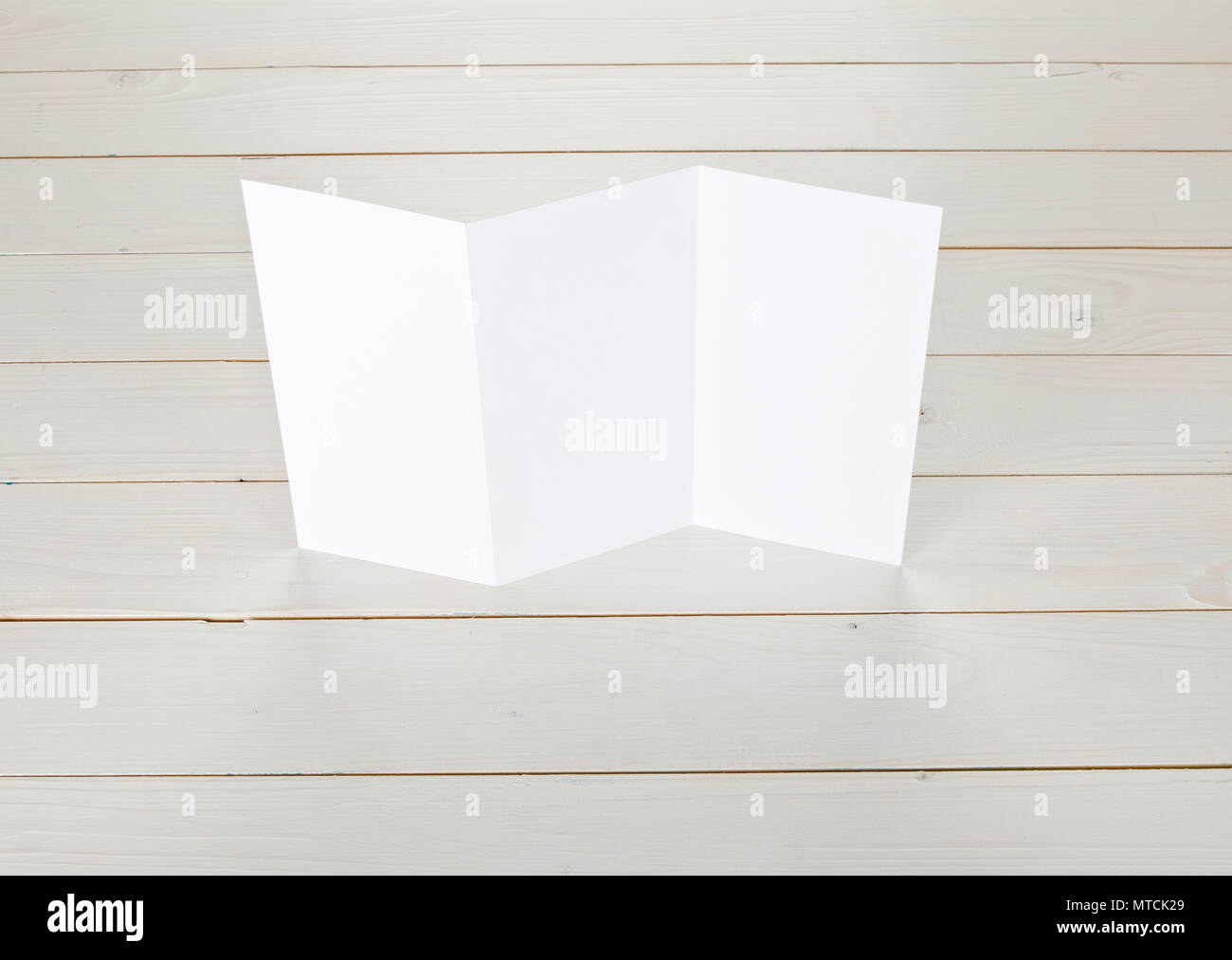 Blank folding page booklet on wooden background Stock Photo - Alamy