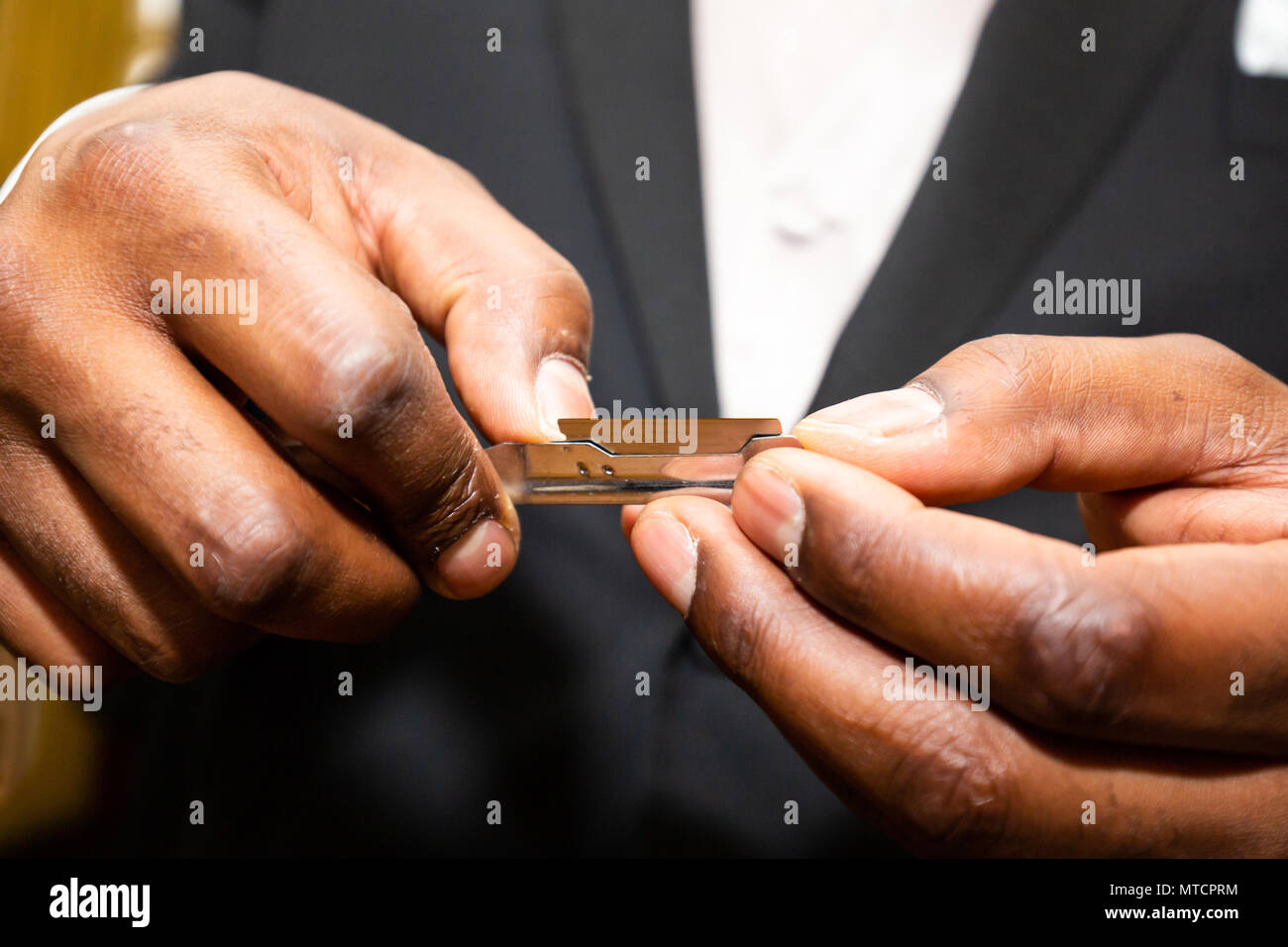Wedding day preparation for groom trimming beard Stock Photo - Alamy