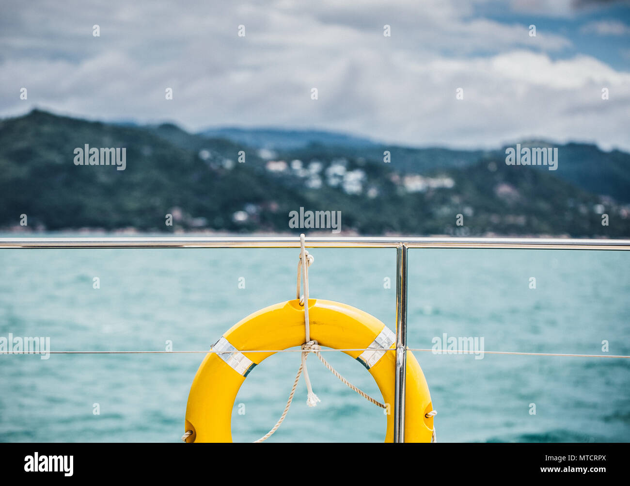 Close-up Yellow life ring hanging on boat with ocean background Stock ...