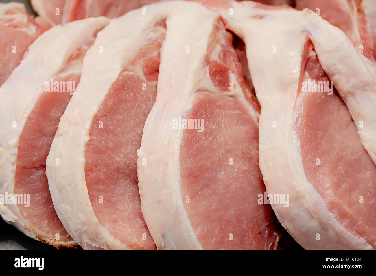 Image of many raw pork chops on counter Stock Photo - Alamy