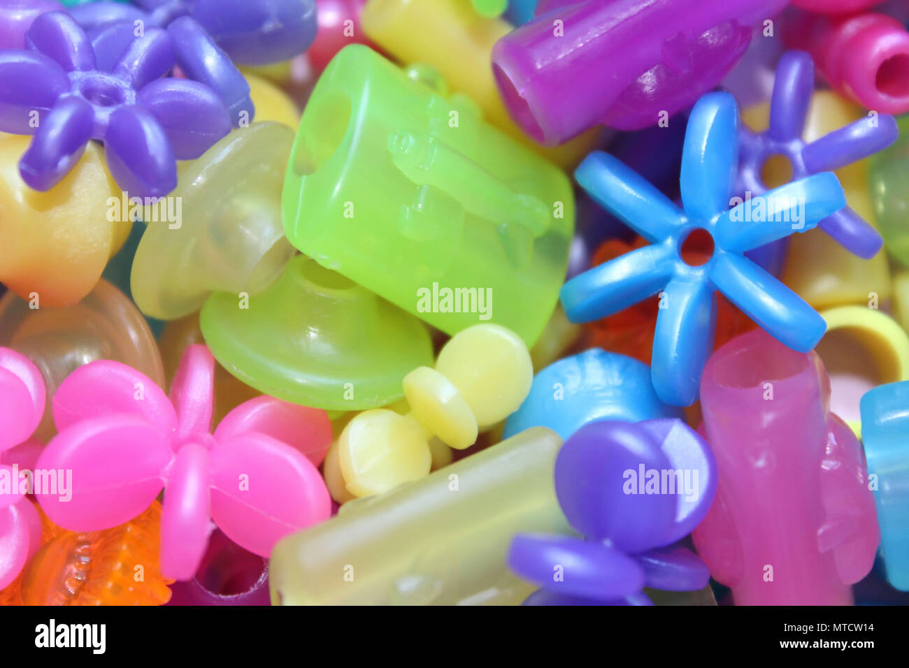 A close up shot of a colorful plastic beads for children in a range of ...