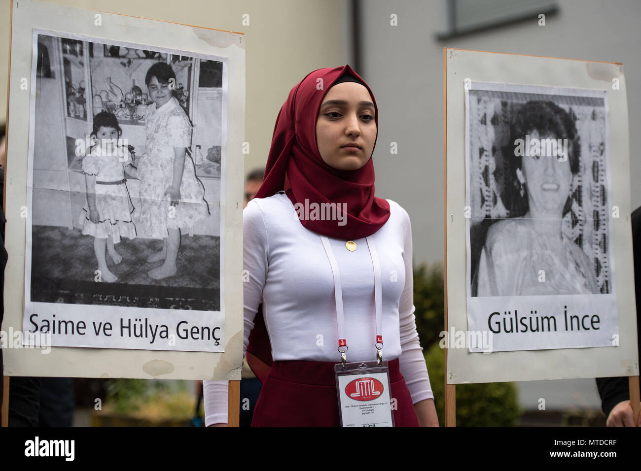 Solingen, Germany. 29 May 2018. A young woman carries pictures of the ...