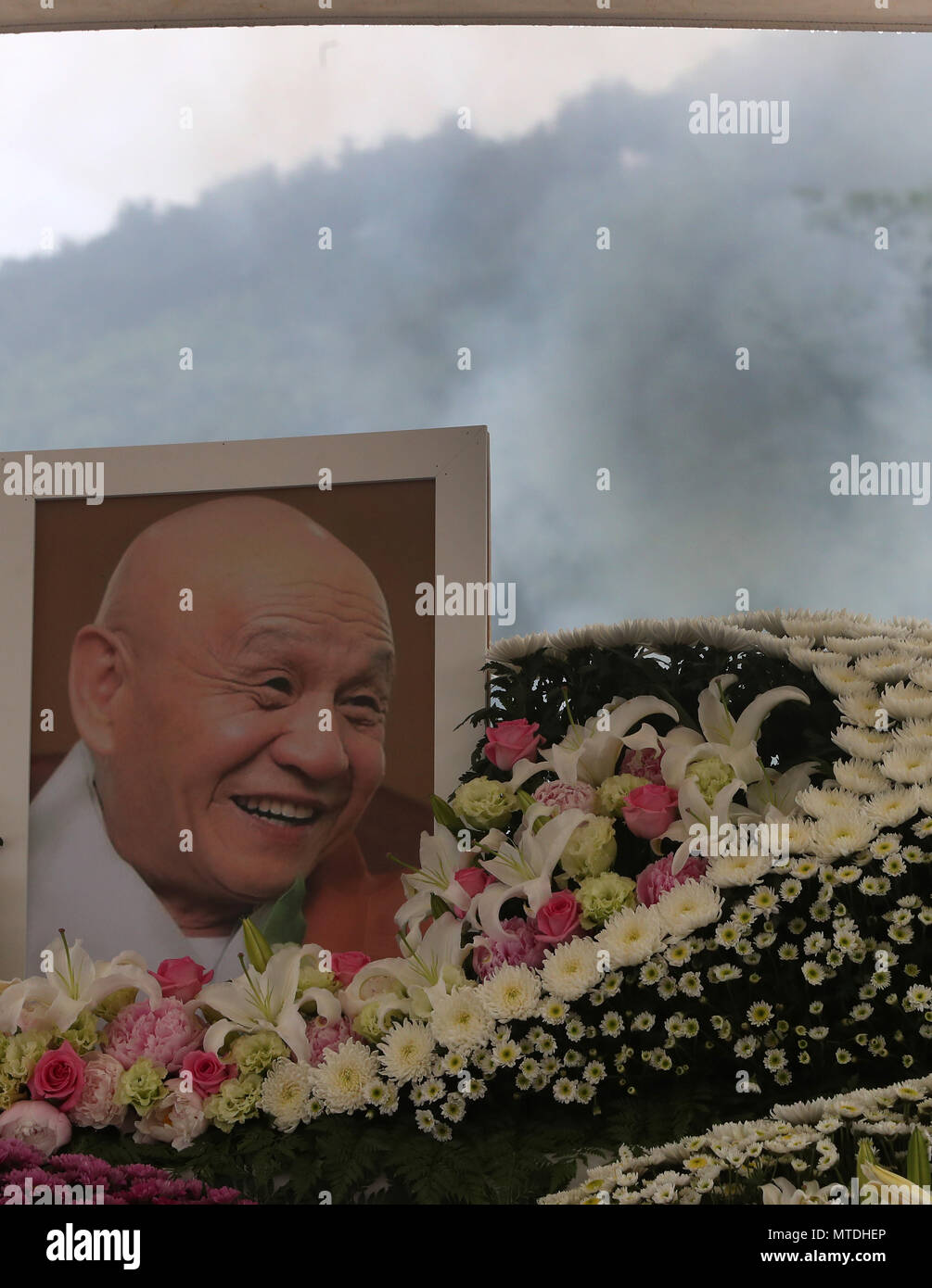 30th May, 2018. Funeral for senior monk White smoke billows from behind ...