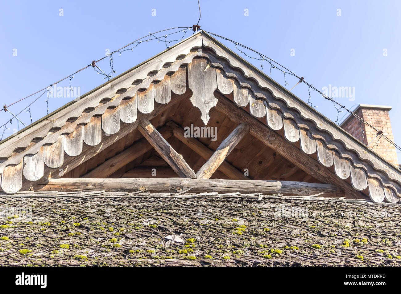 The upper part of the wooden gable roof. Wooden decoration. The roof is ...