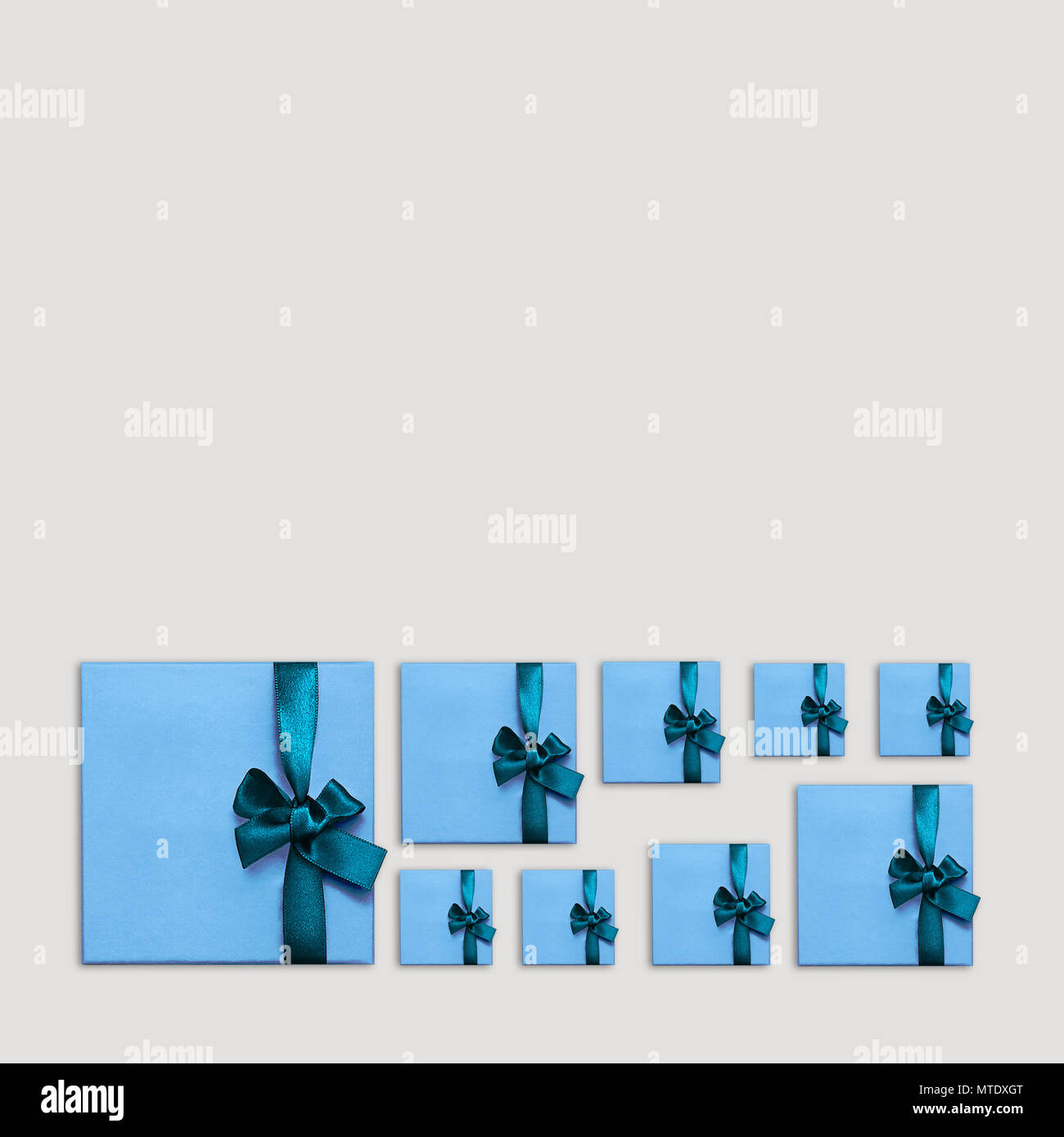 Gift box Minimalist style Blue gift boxes are lying in rows on light ...