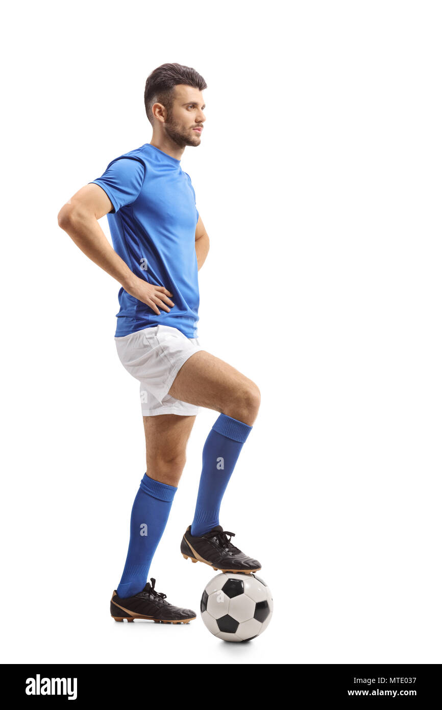 Full length profile shot of a soccer player with a football waiting in ...