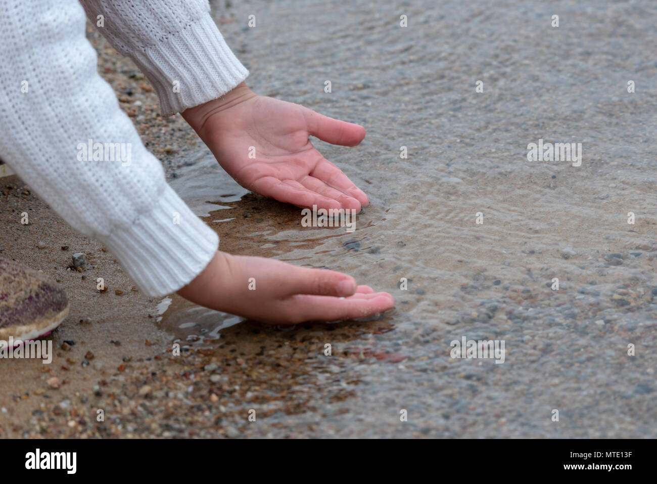 Childs hands feeling the water Stock Photo - Alamy