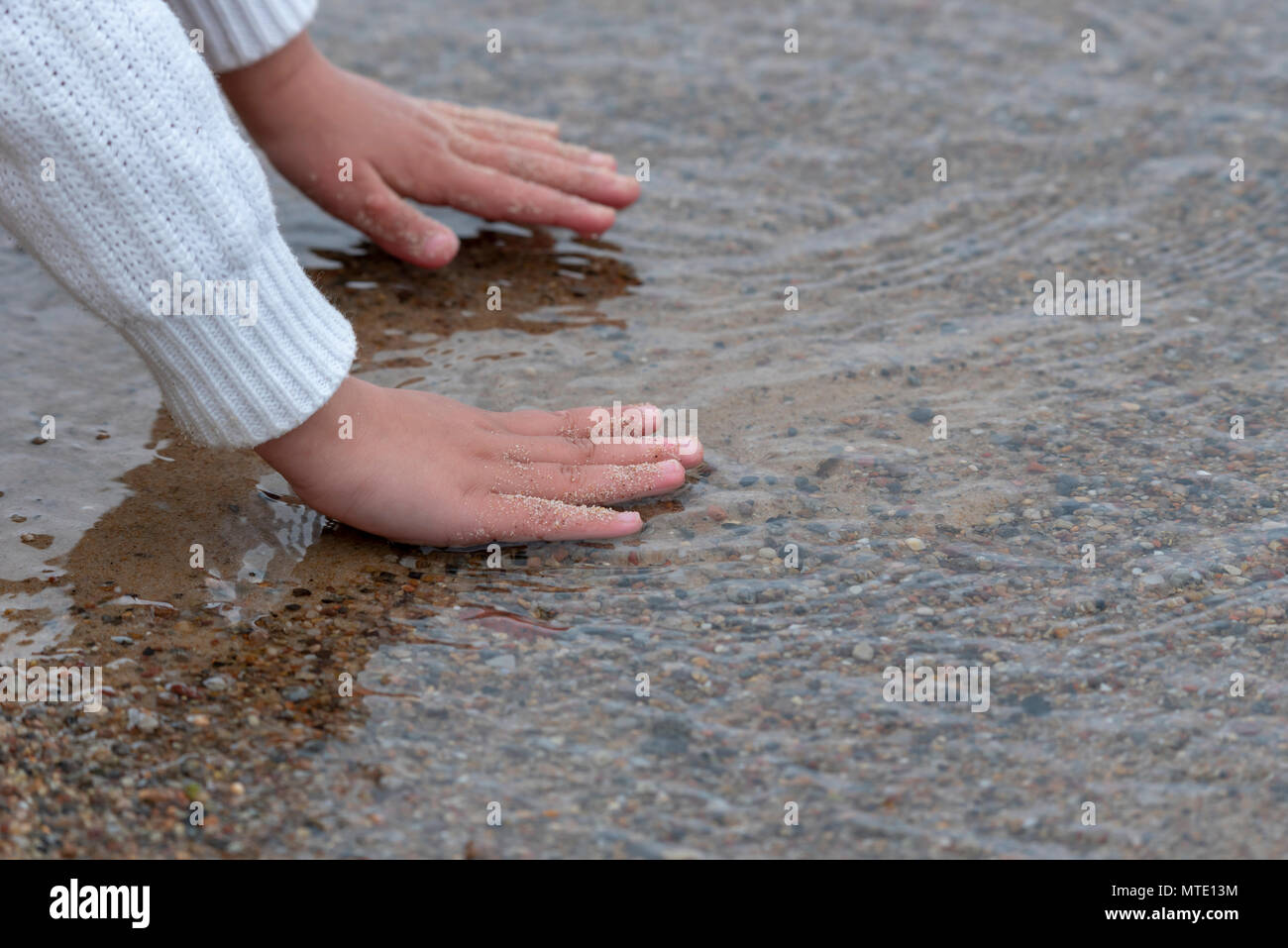 Child touching water hi-res stock photography and images - Alamy