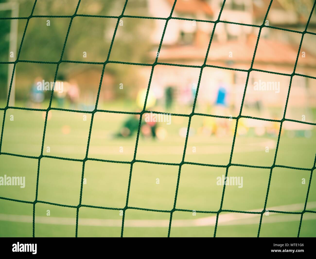 Goal a soccer net with green grass field. Detail of bound strings and ...