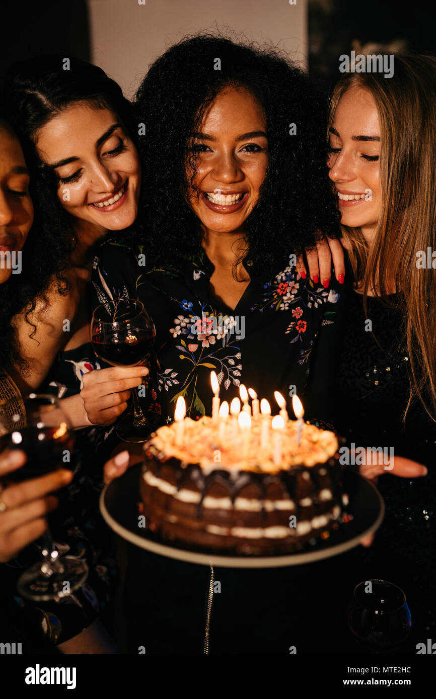 Group of young women celebrating birthday at home Stock Photo - Alamy