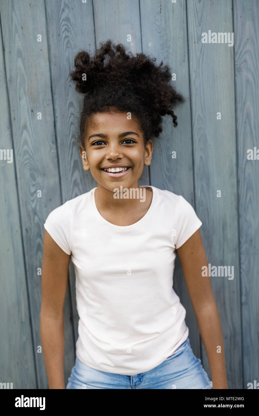 Cute smiling girl looking at camera, standing outdoors Stock Photo - Alamy