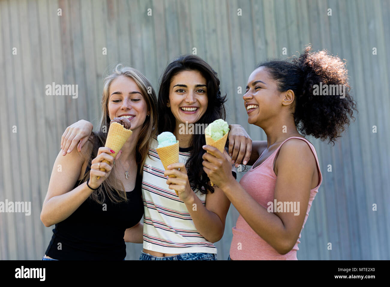 Three girls eating ice cream hi-res stock photography and images - Alamy