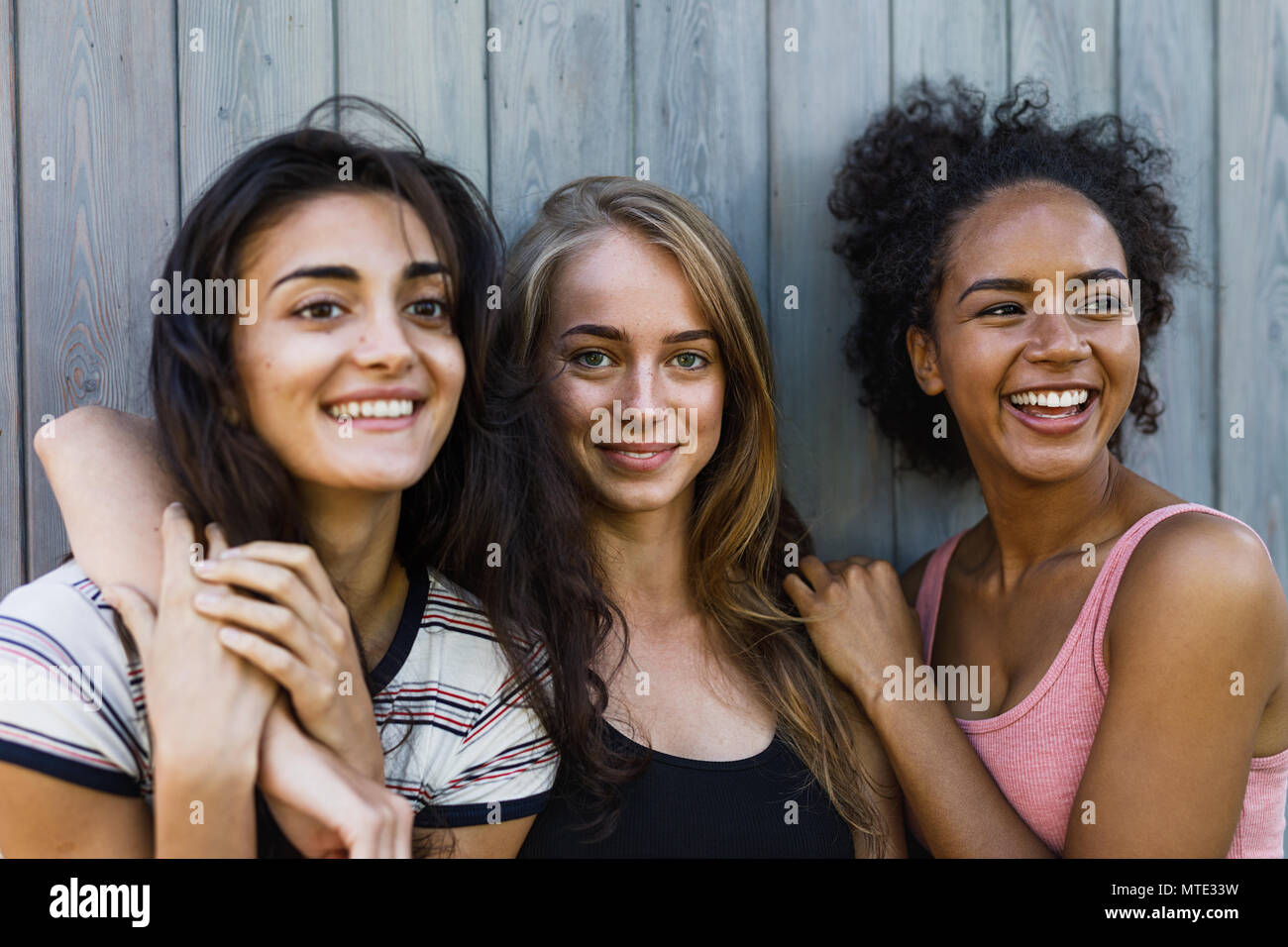 Three beautiful smiling women standing together, outdoor shot Stock ...