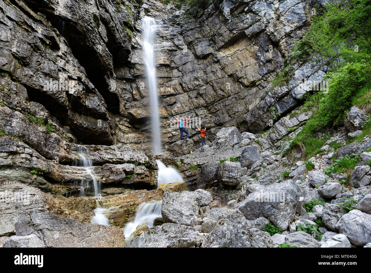 mother and son at waterfall, raising hands Stock Photo - Alamy