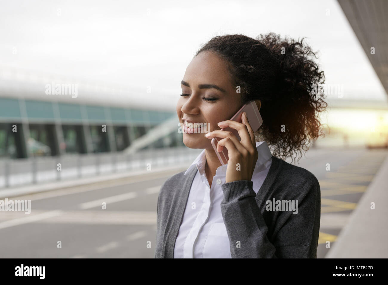 Young woman talking on mobile phone with her eyes closed Stock Photo ...