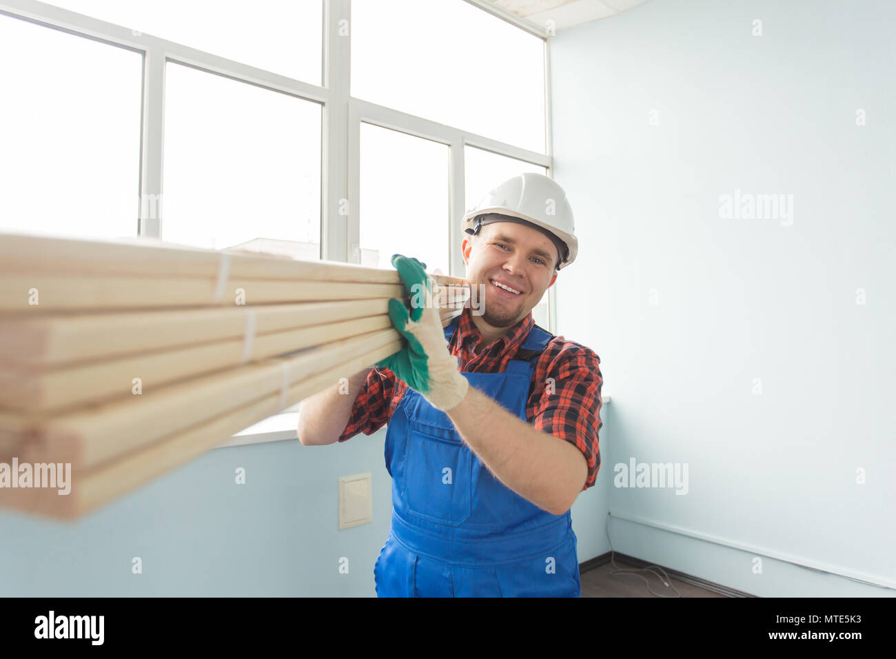 Construction worker in new house. Renovation background Stock Photo - Alamy