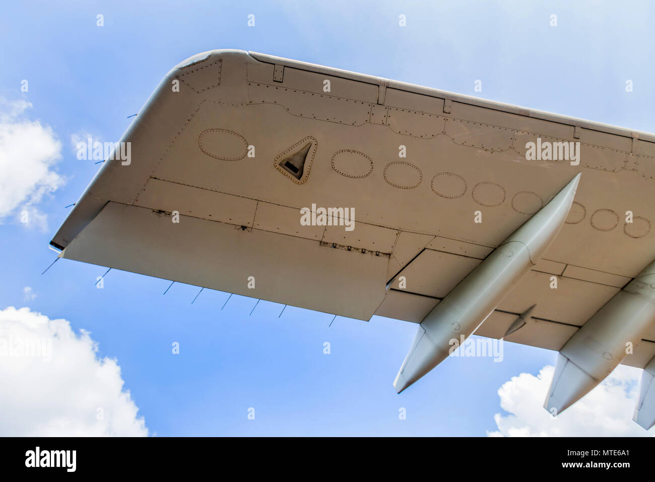 an passenger airplane wing from underneath Stock Photo - Alamy