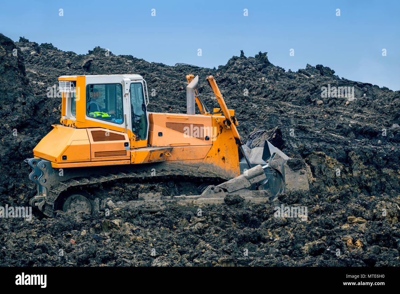 Dozer machine leveling earth outdoors. Construction bulldozer working ...