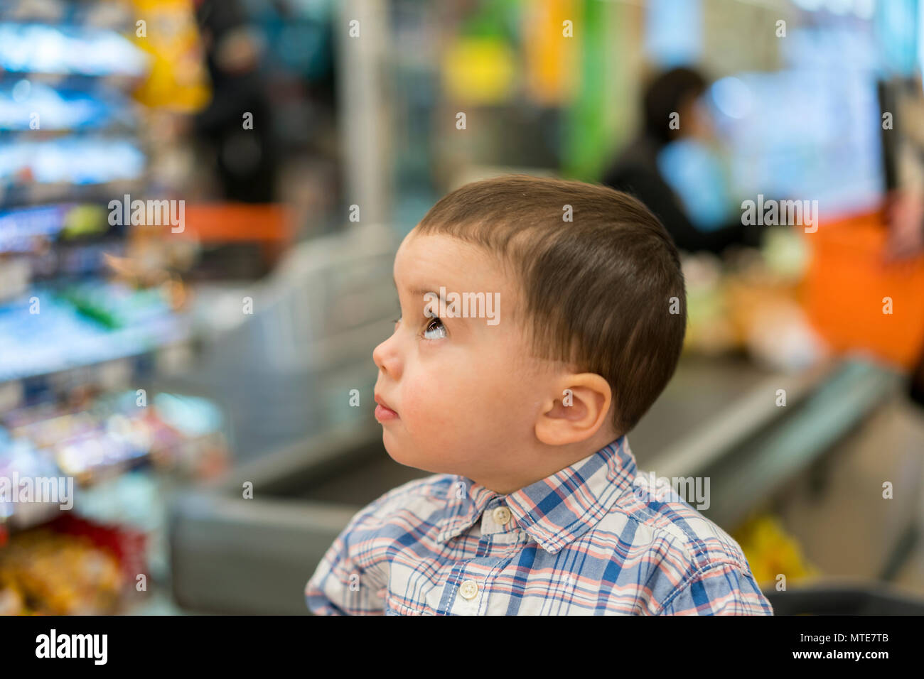 The little boy on a background of cash in a supermarket Stock Photo - Alamy