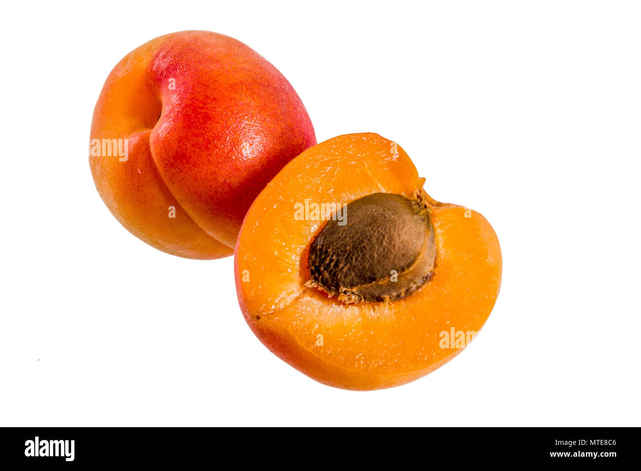 Apricots, whole and halved, isolated on white background Stock Photo ...