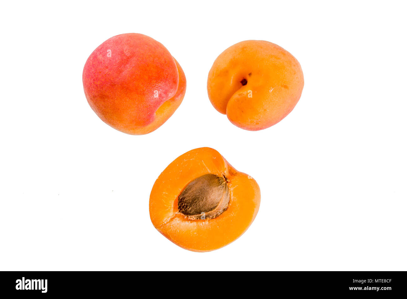 Apricots, whole and halved, isolated on white background Stock Photo ...