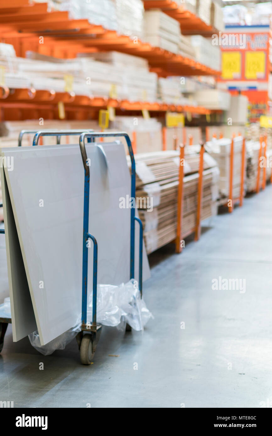Rows of shelves with boxes and storage carts in modern warehouse Stock ...