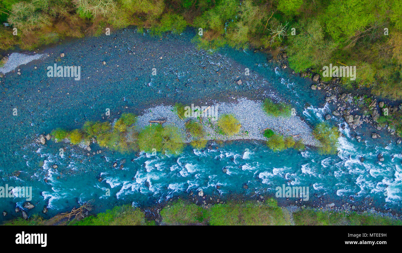 Top-down drone view of rapids of mountain river with wet boulders and ...