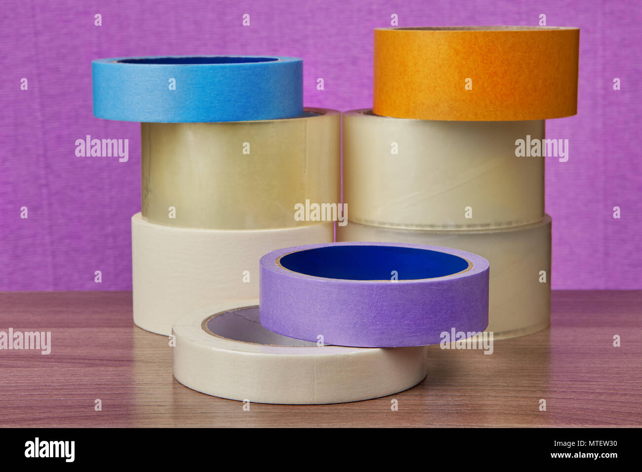 Transparent BOPP packing tape and masking paper tape on an purple ...